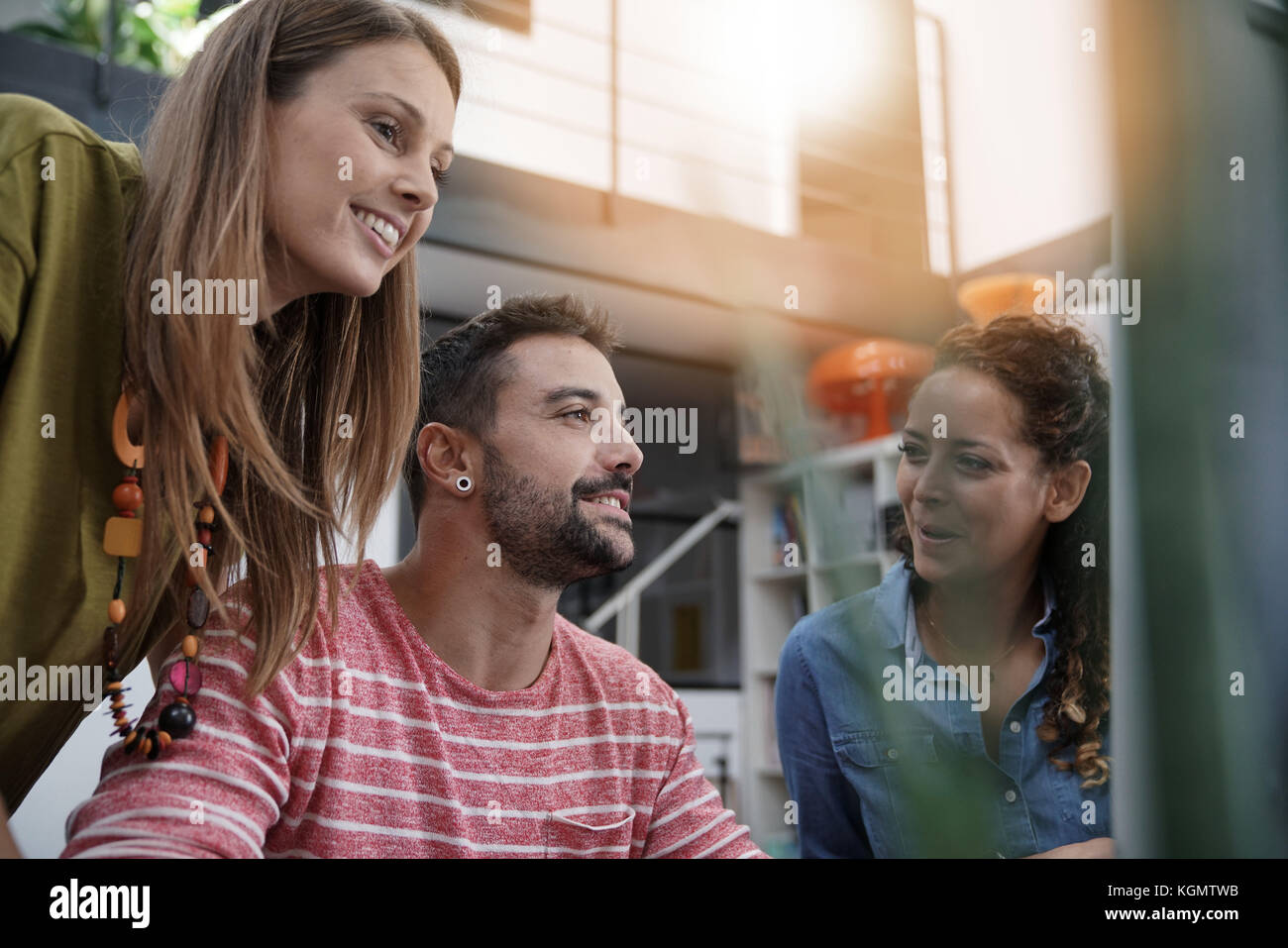 Start-up people working on desktop in co-working space Stock Photo - Alamy