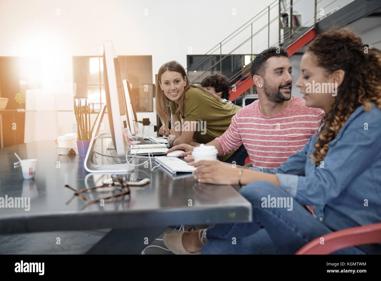 Start-up people working on desktop in co-working space Stock Photo - Alamy