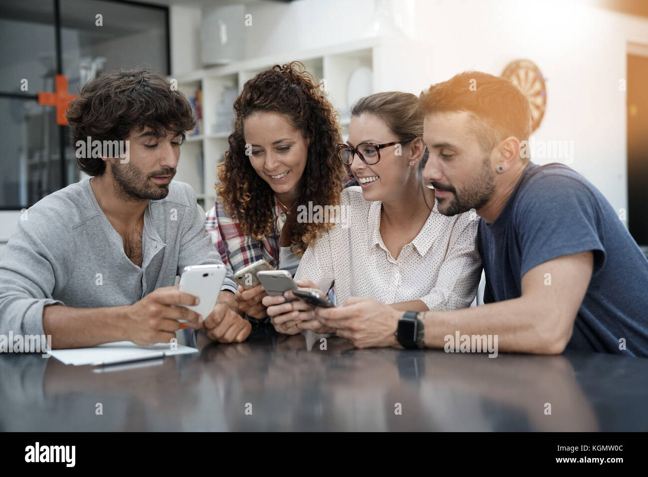 Young people having fun using smartphones Stock Photo - Alamy