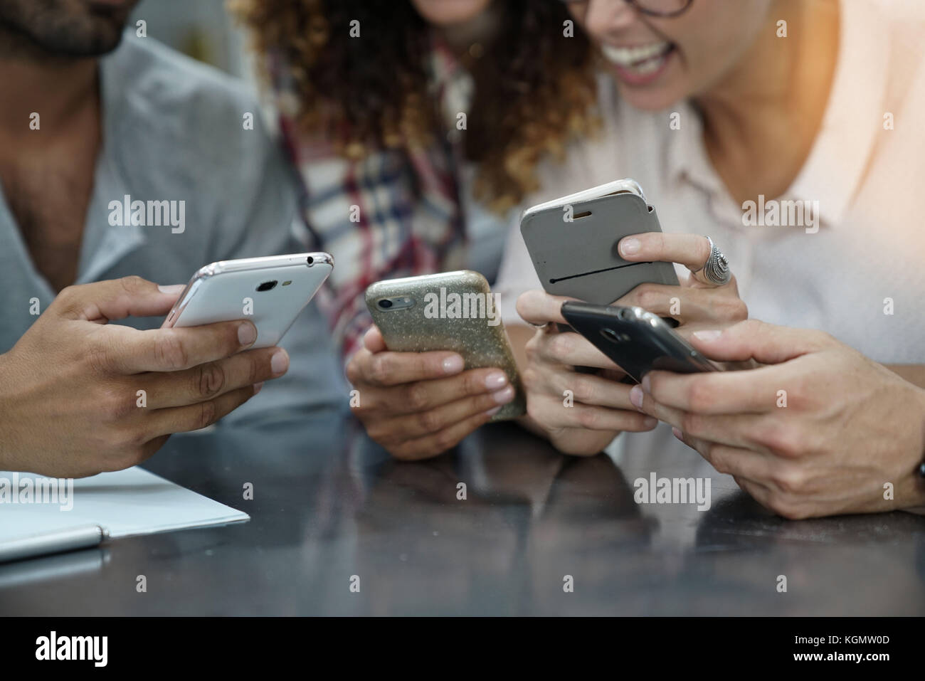Young people having fun using smartphones Stock Photo - Alamy