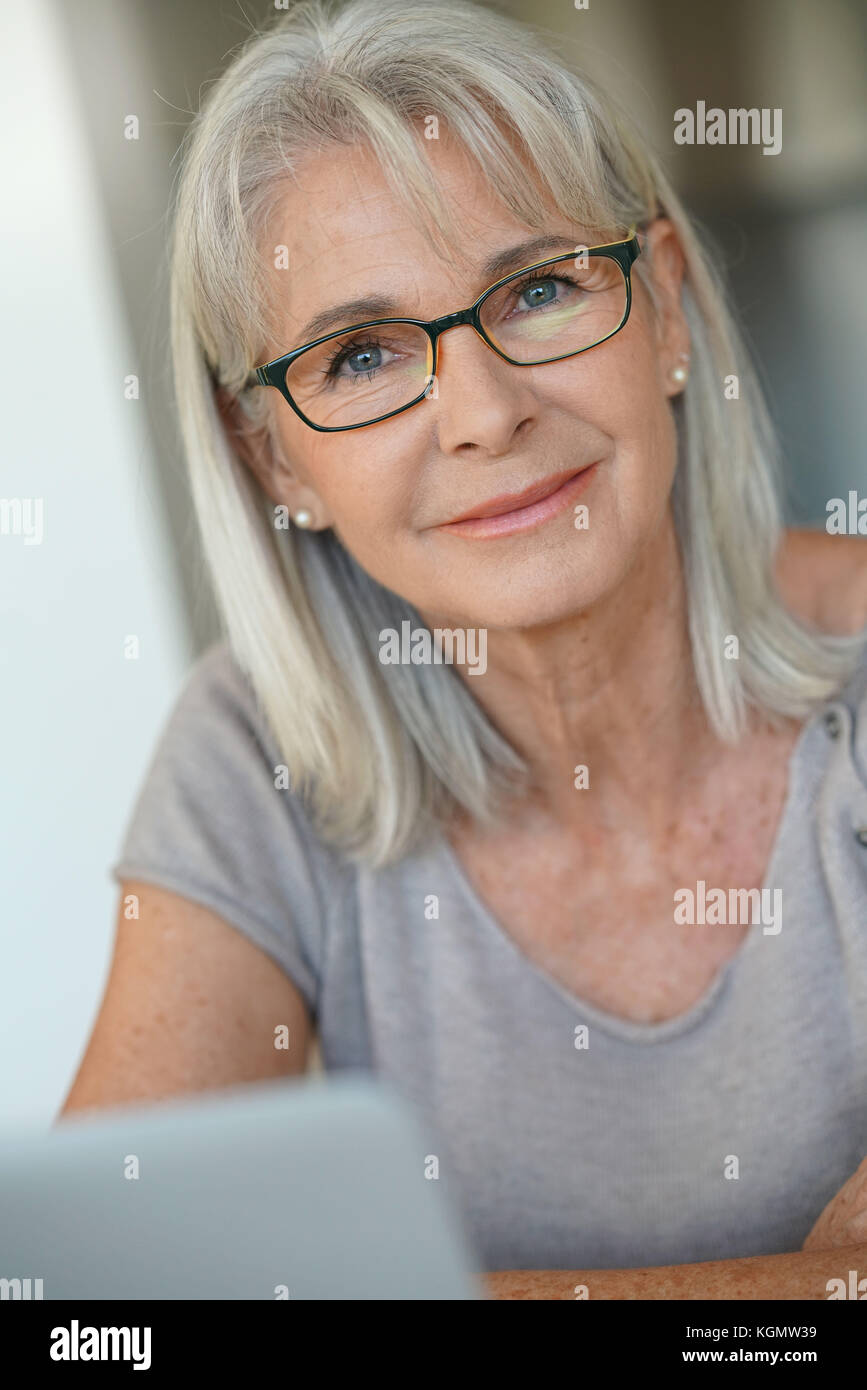 Senior woman with eyeglasses using laptop Stock Photo - Alamy