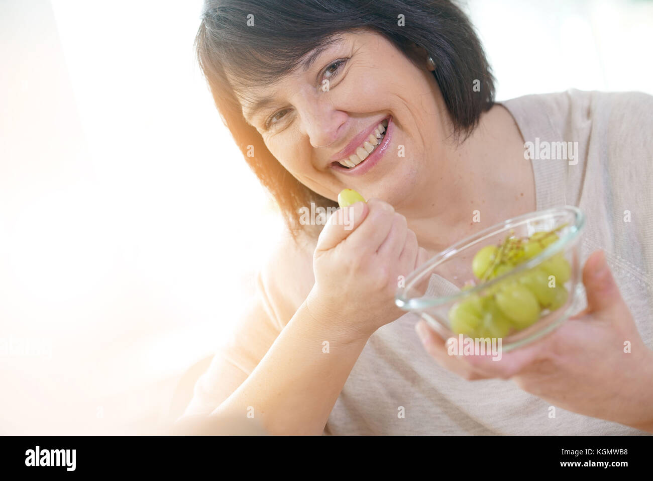 Woman eating grapes hi-res stock photography and images - Alamy