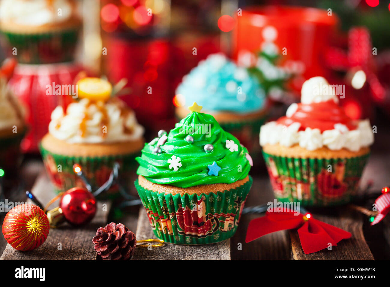 Set of different delicious Christmas cupcakes on holiday background ...