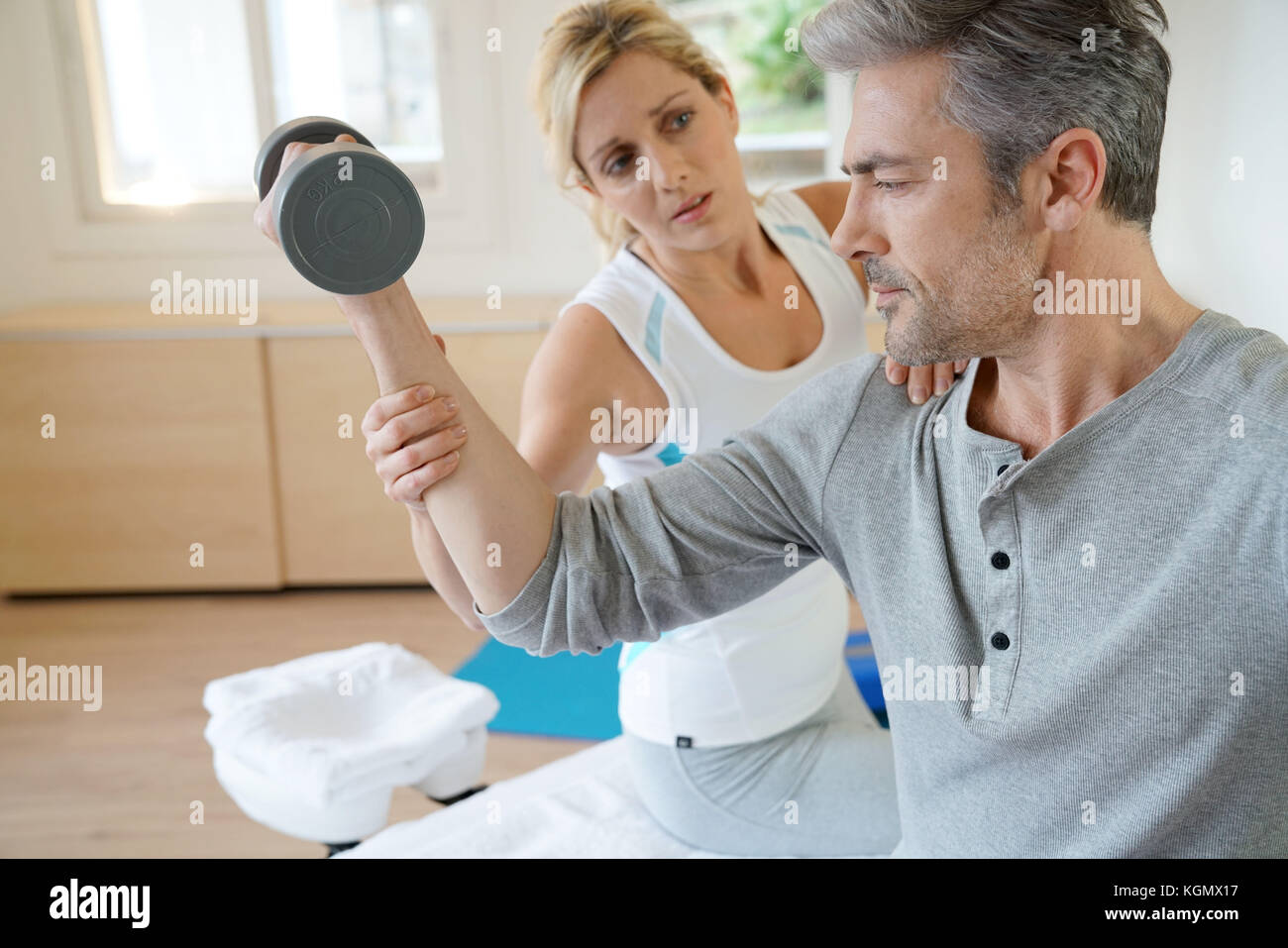 Physiotherapist woman man dumbbells hi-res stock photography and images ...