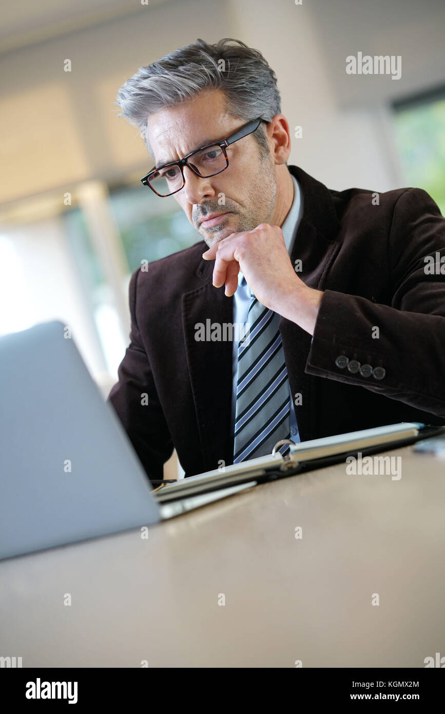 Attorney working in office on laptop Stock Photo - Alamy