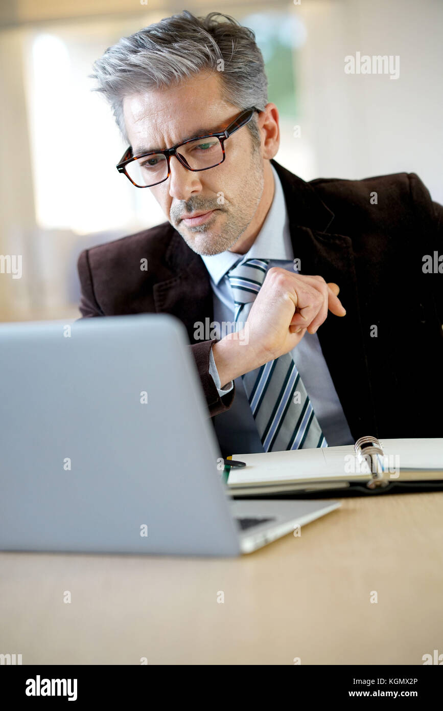 Attorney working in office on laptop Stock Photo - Alamy