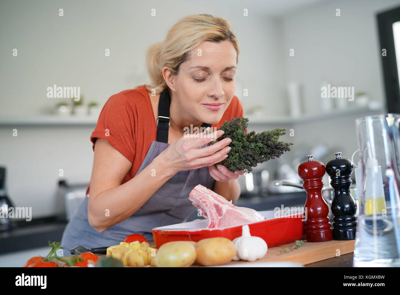Woman in kitchen cooking dish for dinner Stock Photo - Alamy