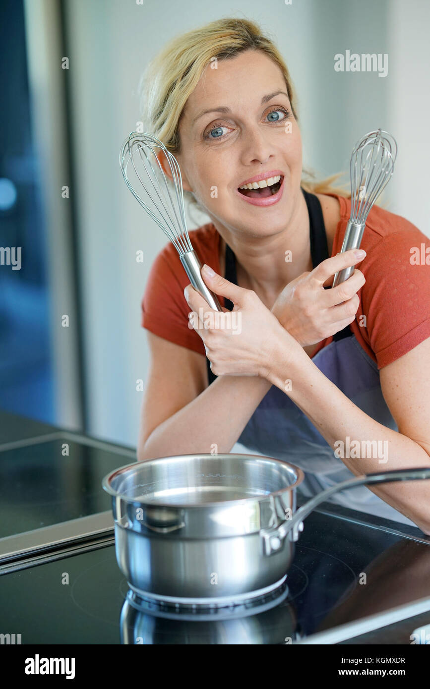 Portrait of woman in kitchen ready to cook pastry Stock Photo - Alamy
