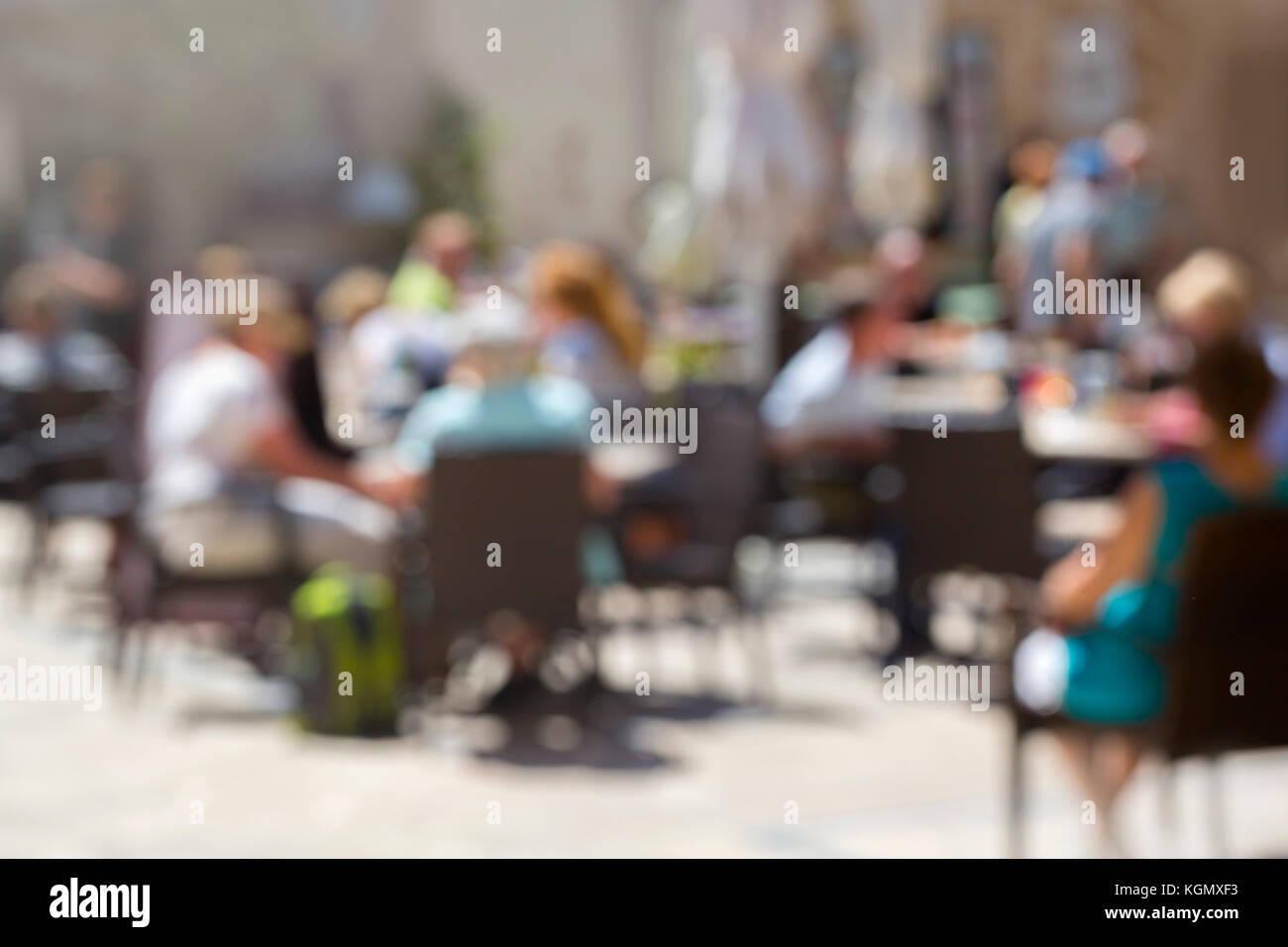 Background of blurred cafe on street of city. Tables and chairs outside ...