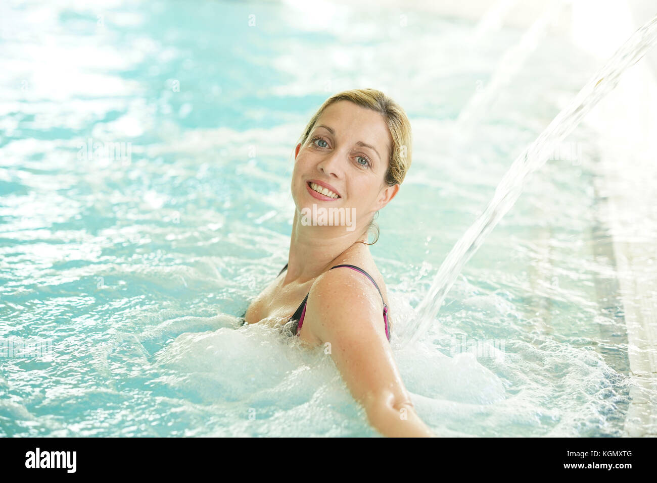 Woman in spa pool enjoying water jet Stock Photo - Alamy