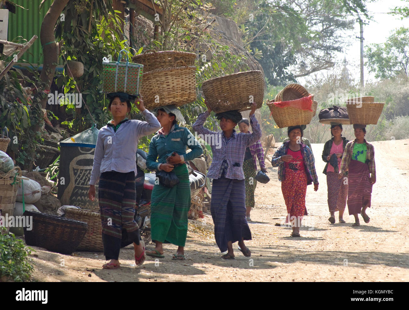 Women balancing baskets of goods on their head in Bagan Myanmar Stock ...