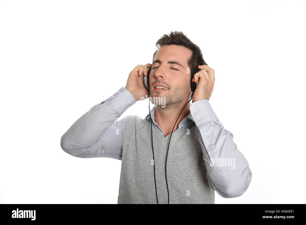 Man relaxing with headset and music player Stock Photo - Alamy