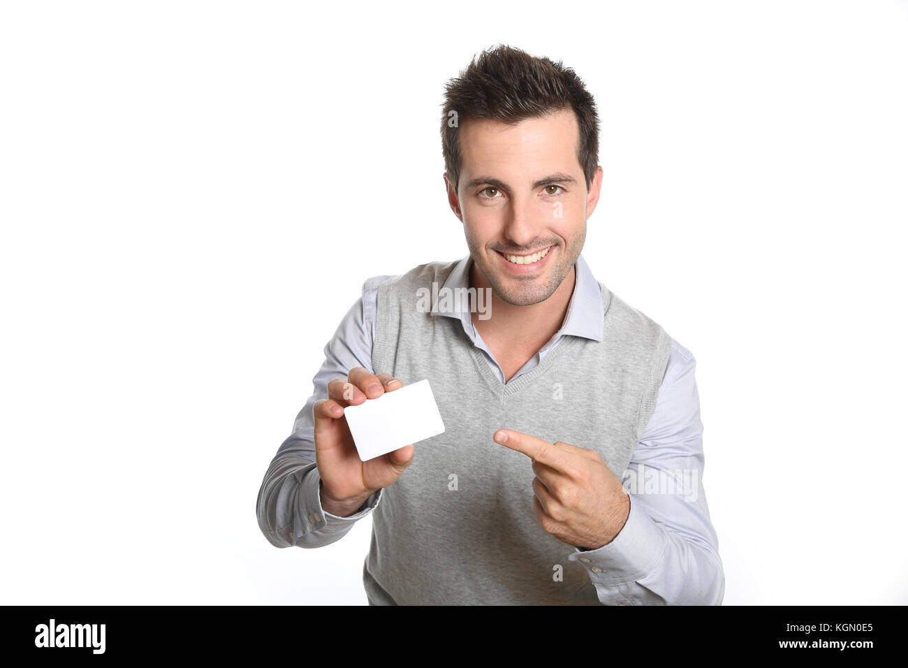 Handsome smiling man showing card Stock Photo - Alamy