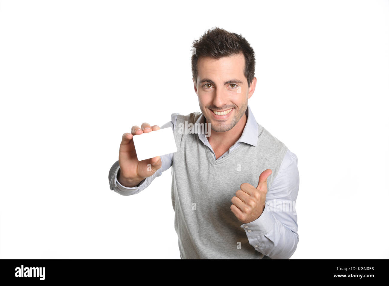 Handsome smiling man showing card with thumb up Stock Photo - Alamy