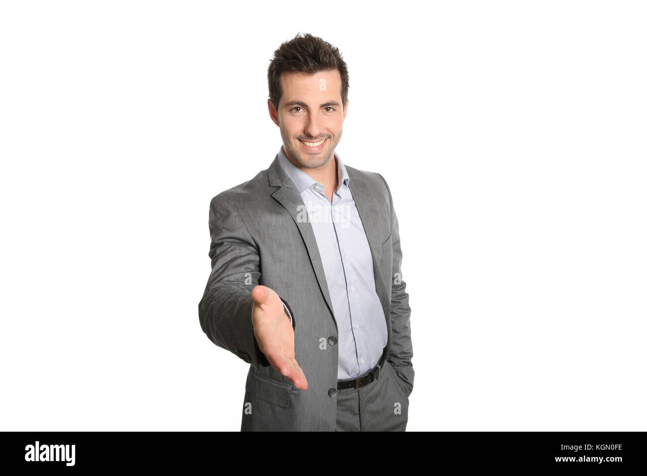 Smiling businessman giving hand for handshake Stock Photo - Alamy