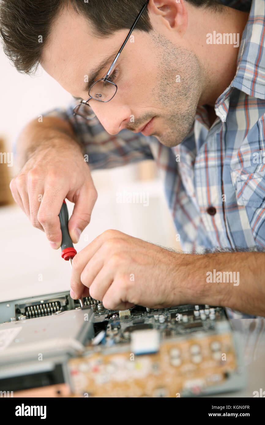 Man fixing electronic appliance Stock Photo - Alamy