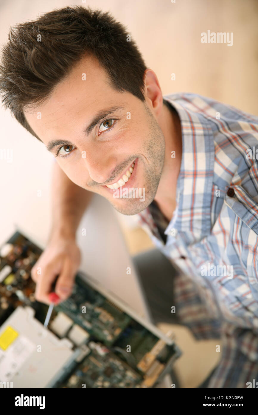 Man fixing electronic appliance Stock Photo - Alamy