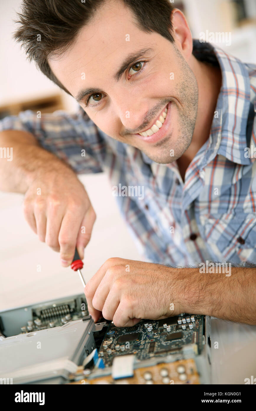 Man fixing electronic appliance Stock Photo - Alamy