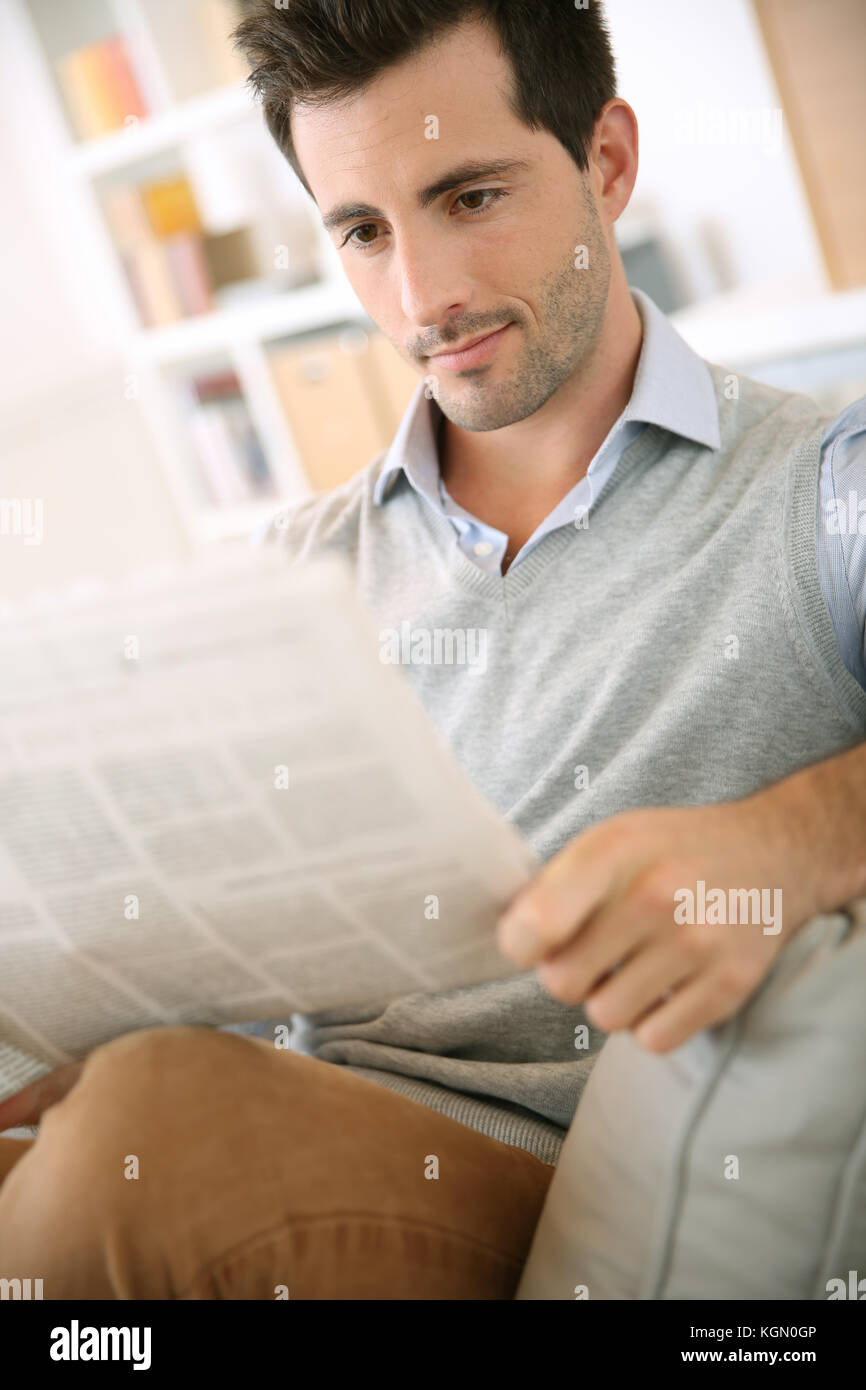 Man at home reading newspaper Stock Photo - Alamy