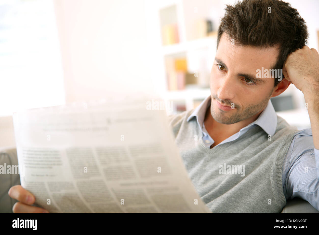 Man at home reading newspaper Stock Photo - Alamy