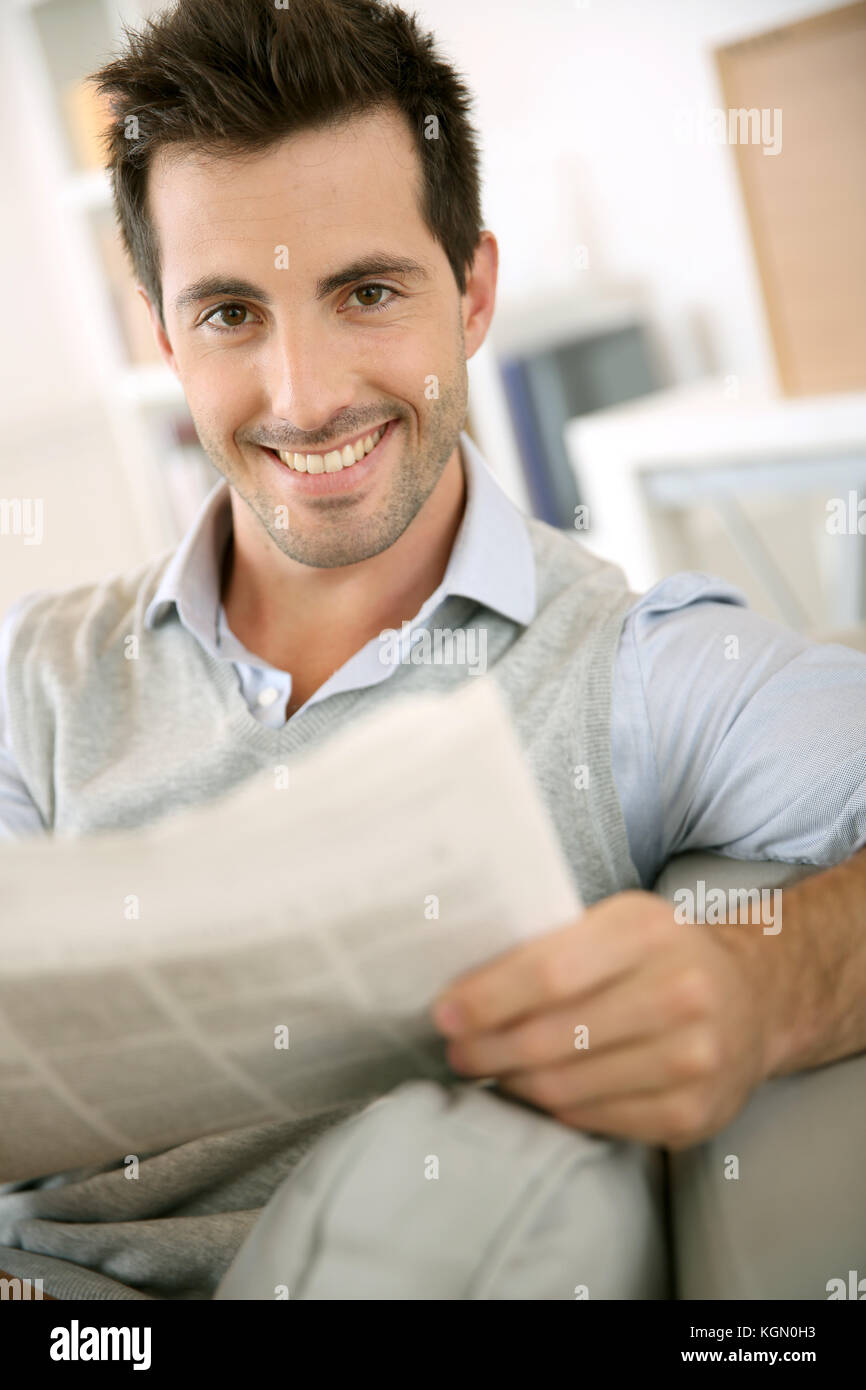 Man at home reading newspaper Stock Photo - Alamy