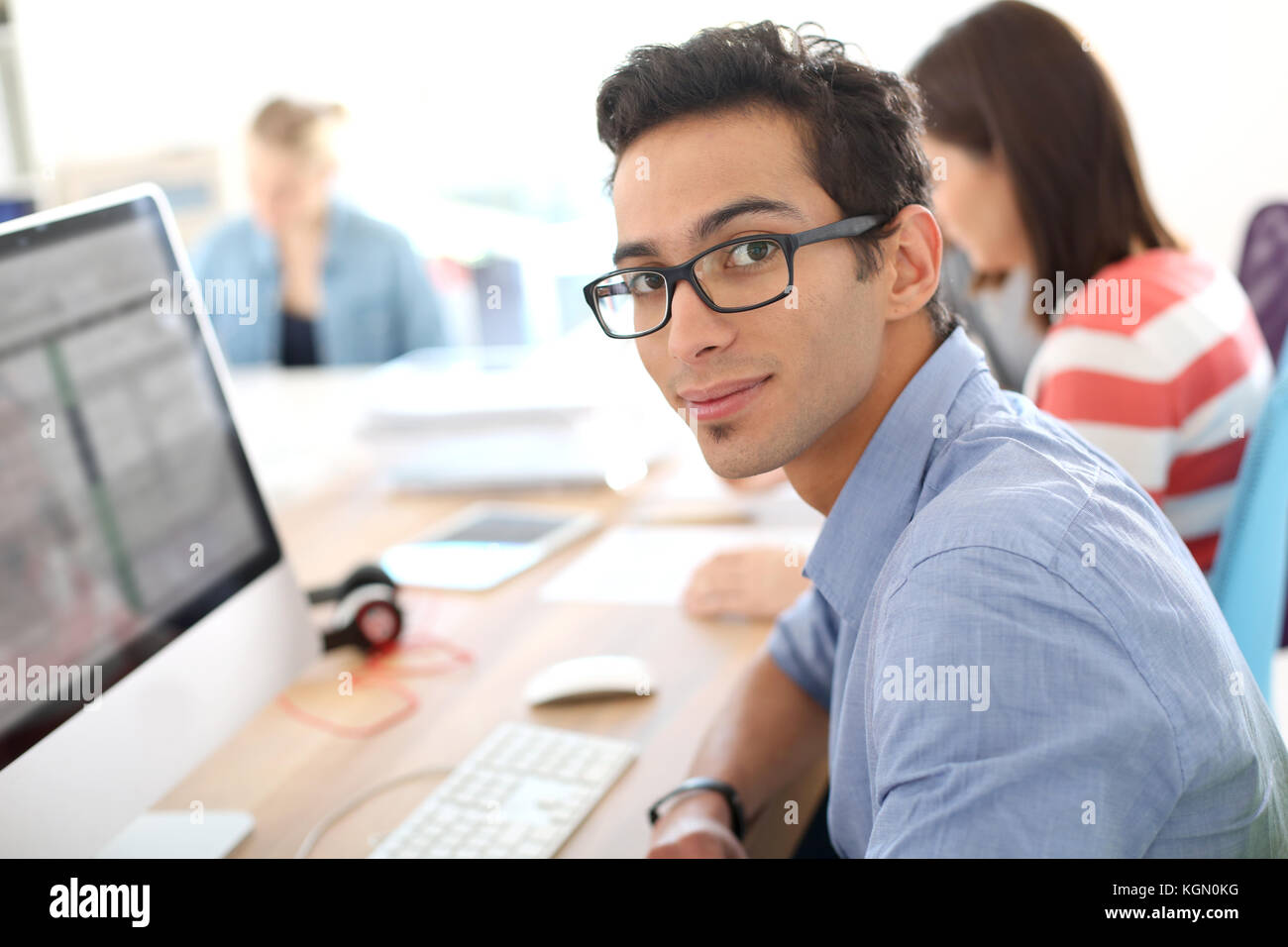 Young man in business apprenticeship Stock Photo - Alamy