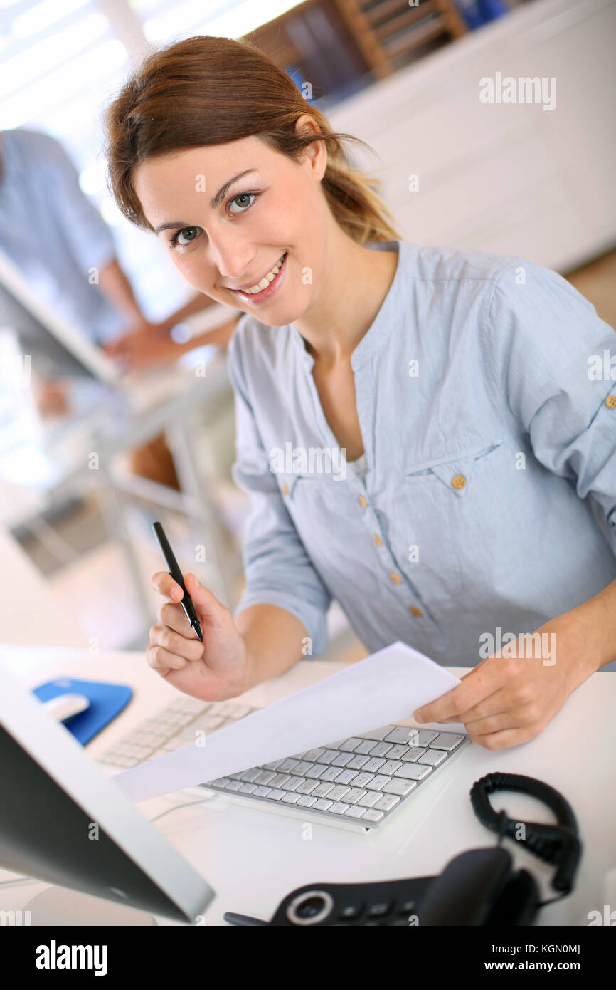 Young woman working on desktop computer Stock Photo - Alamy