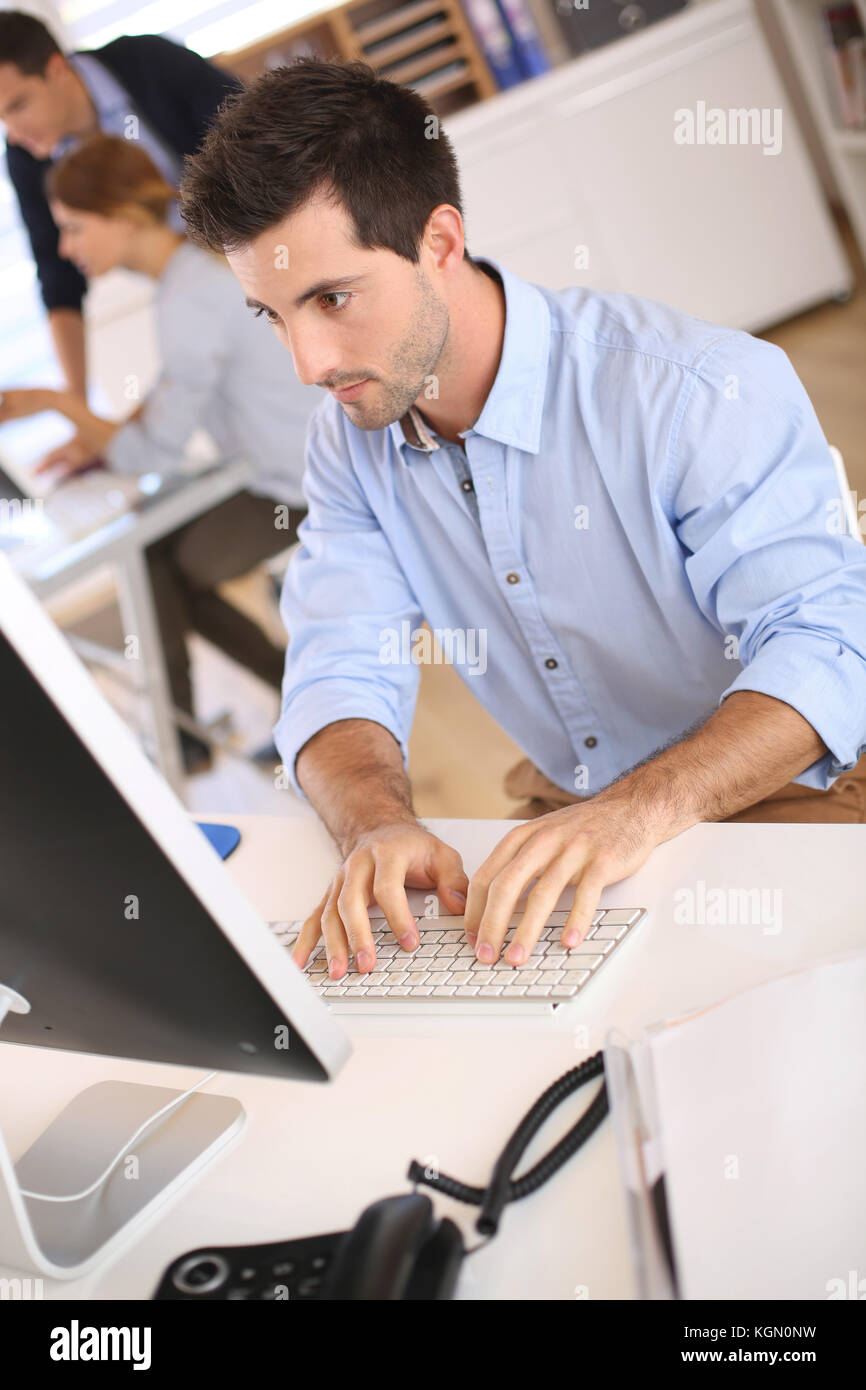 Man in office working on desktop computer Stock Photo - Alamy