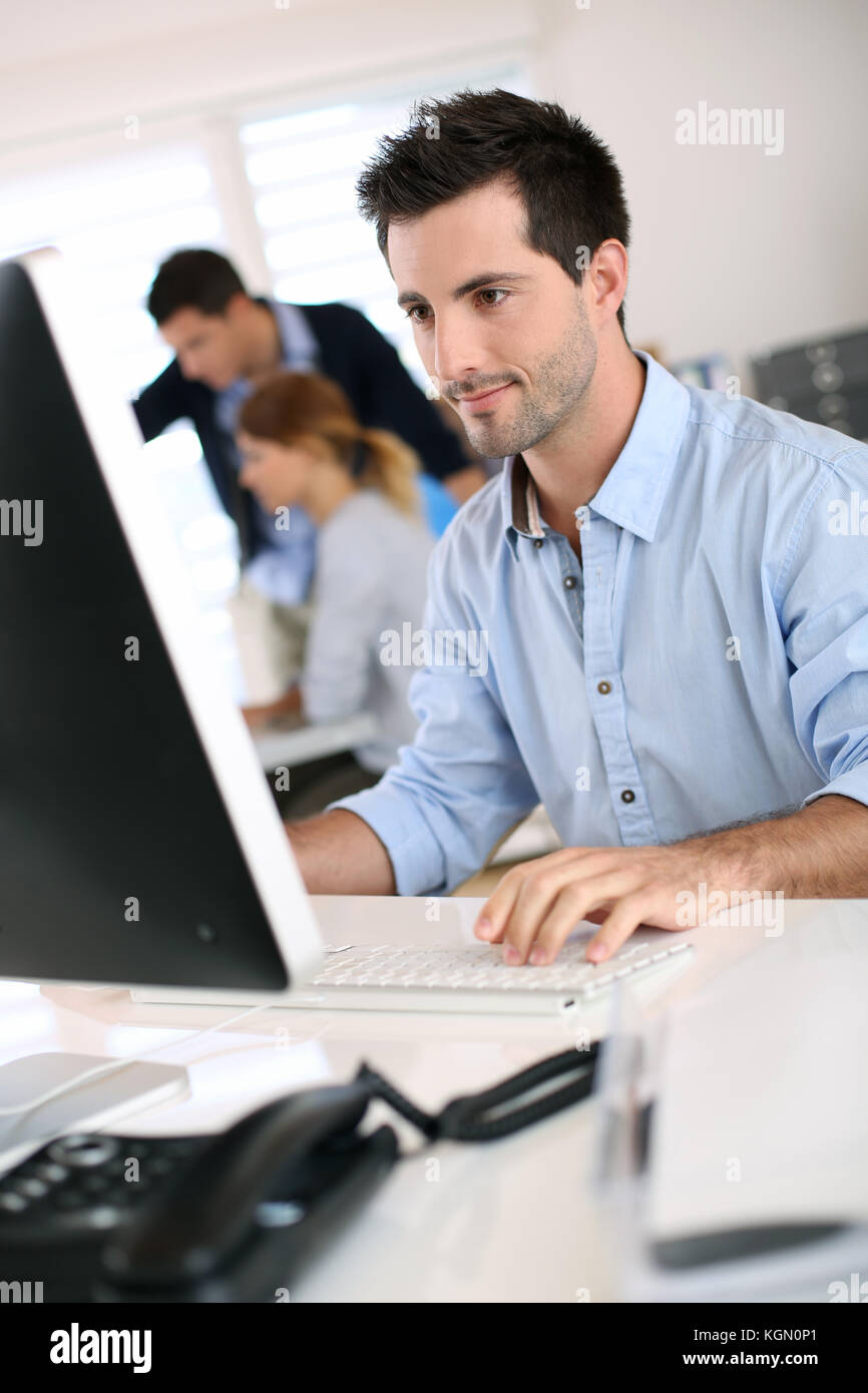 Man in office working on desktop computer Stock Photo - Alamy