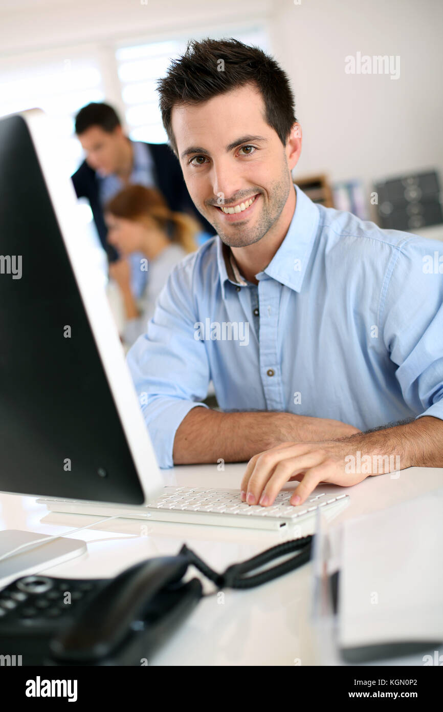 Man in office working on desktop computer Stock Photo - Alamy