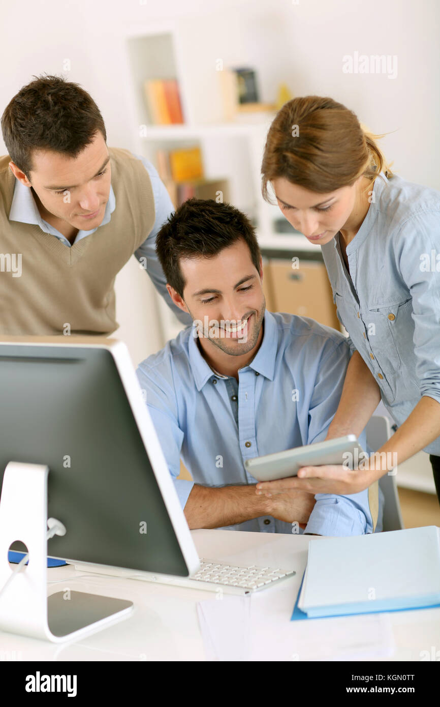 Office workers using tablet and computer Stock Photo - Alamy
