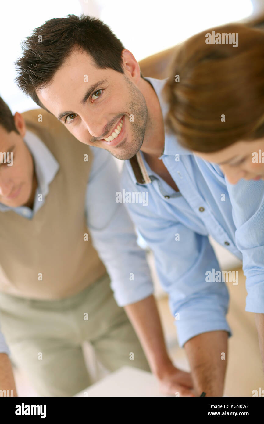 Smiling handsome man working in office Stock Photo - Alamy