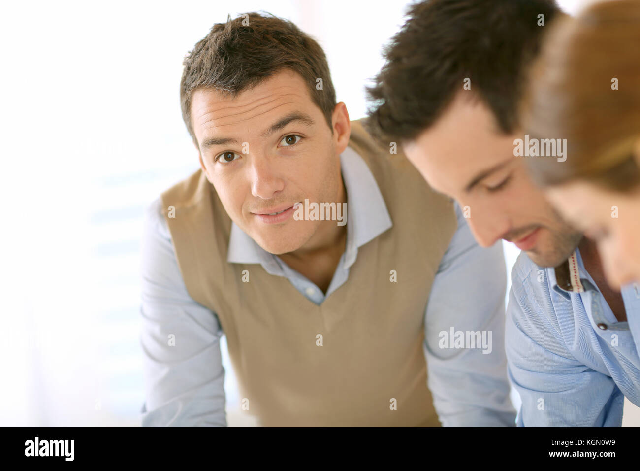 Smiling handsome man working in office Stock Photo - Alamy