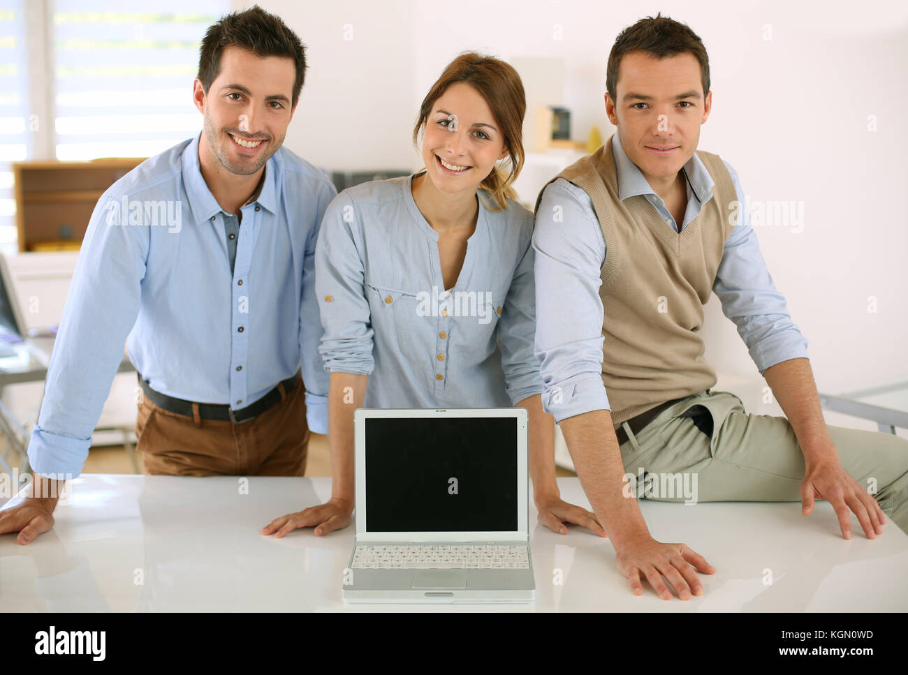 Successful startup people showing laptop screen Stock Photo - Alamy