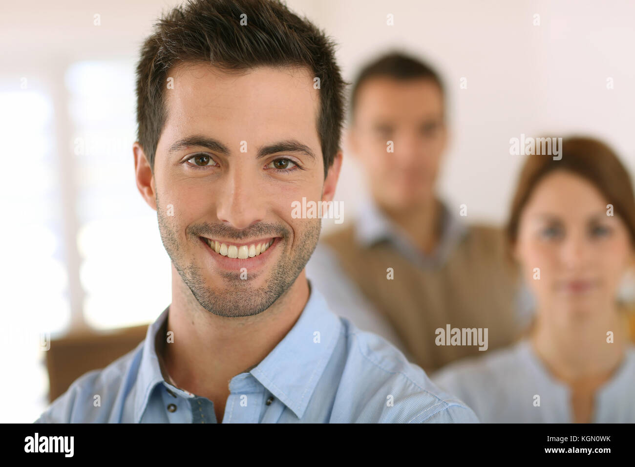 Handsome man standing in front of business team Stock Photo - Alamy