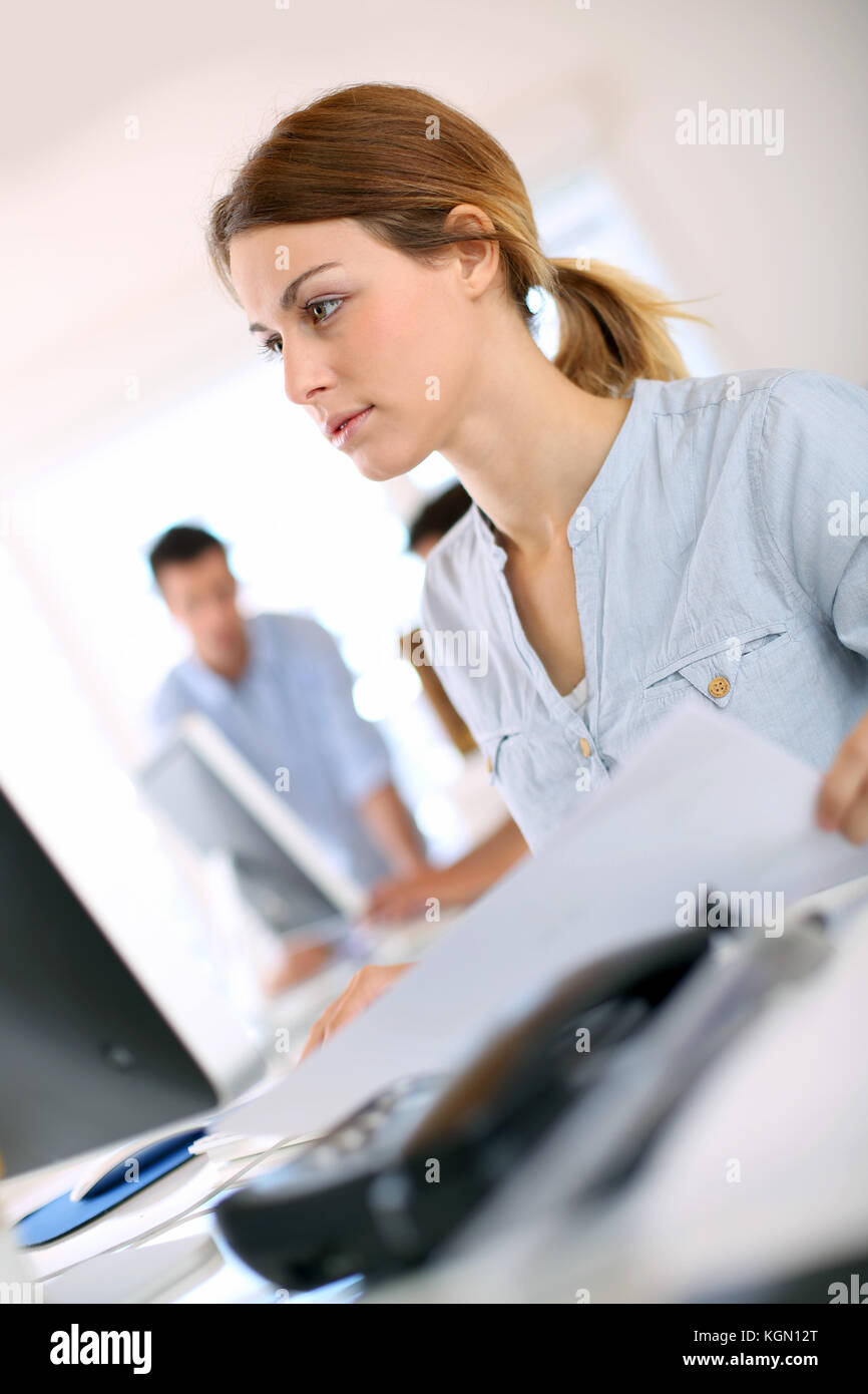 Young woman working on desktop computer Stock Photo - Alamy
