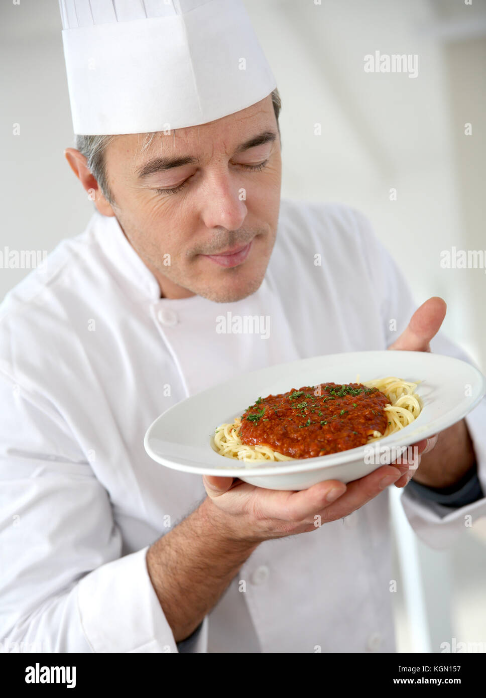 Chef in kitchen preparing italian dish Stock Photo - Alamy