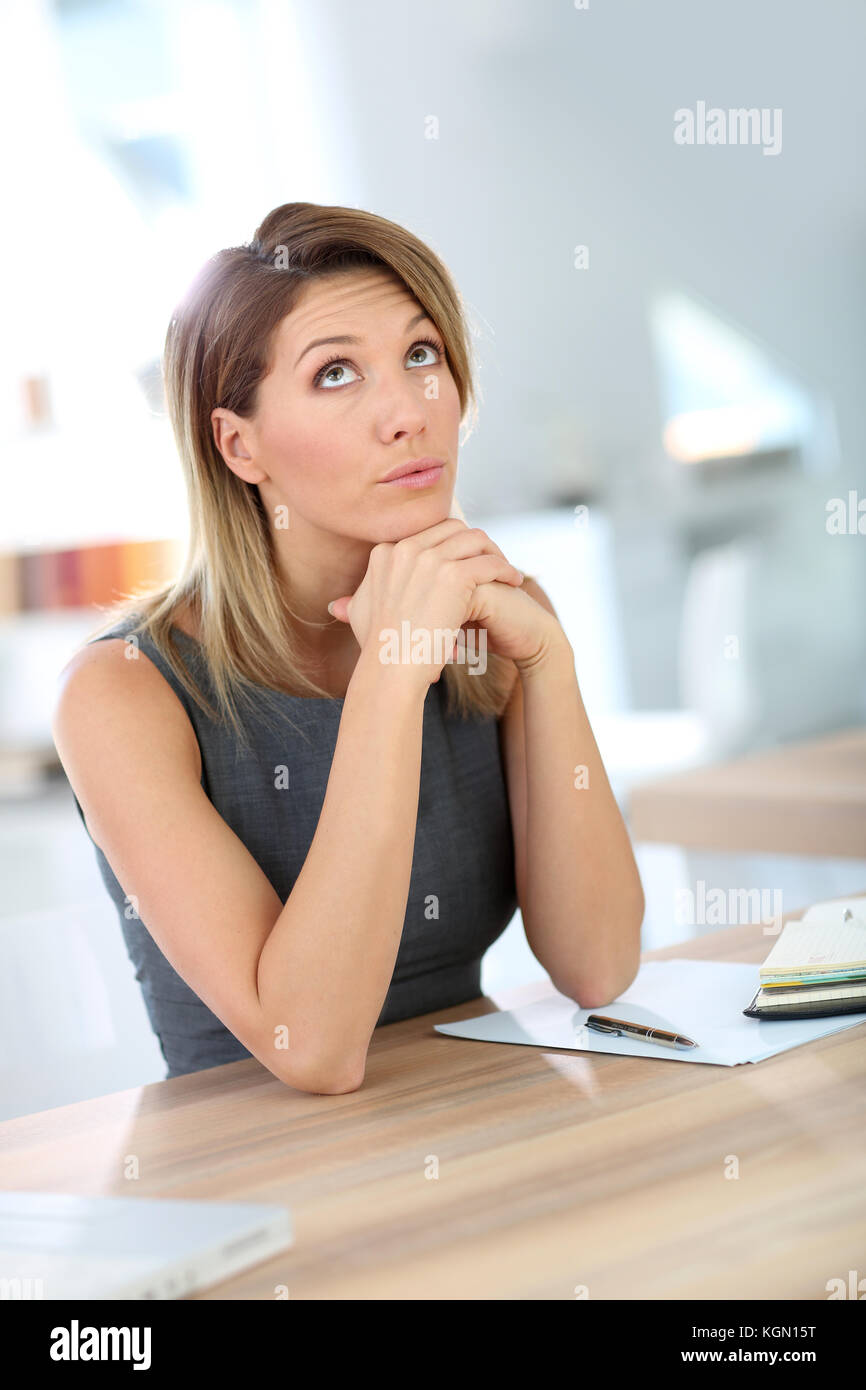 Portrait of businesswoman with thoughtful look Stock Photo - Alamy