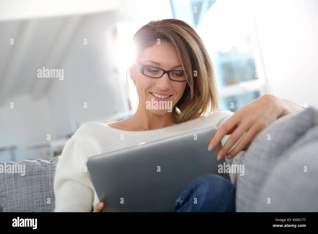 Beautiful blond woman at home websurfing on internet Stock Photo - Alamy