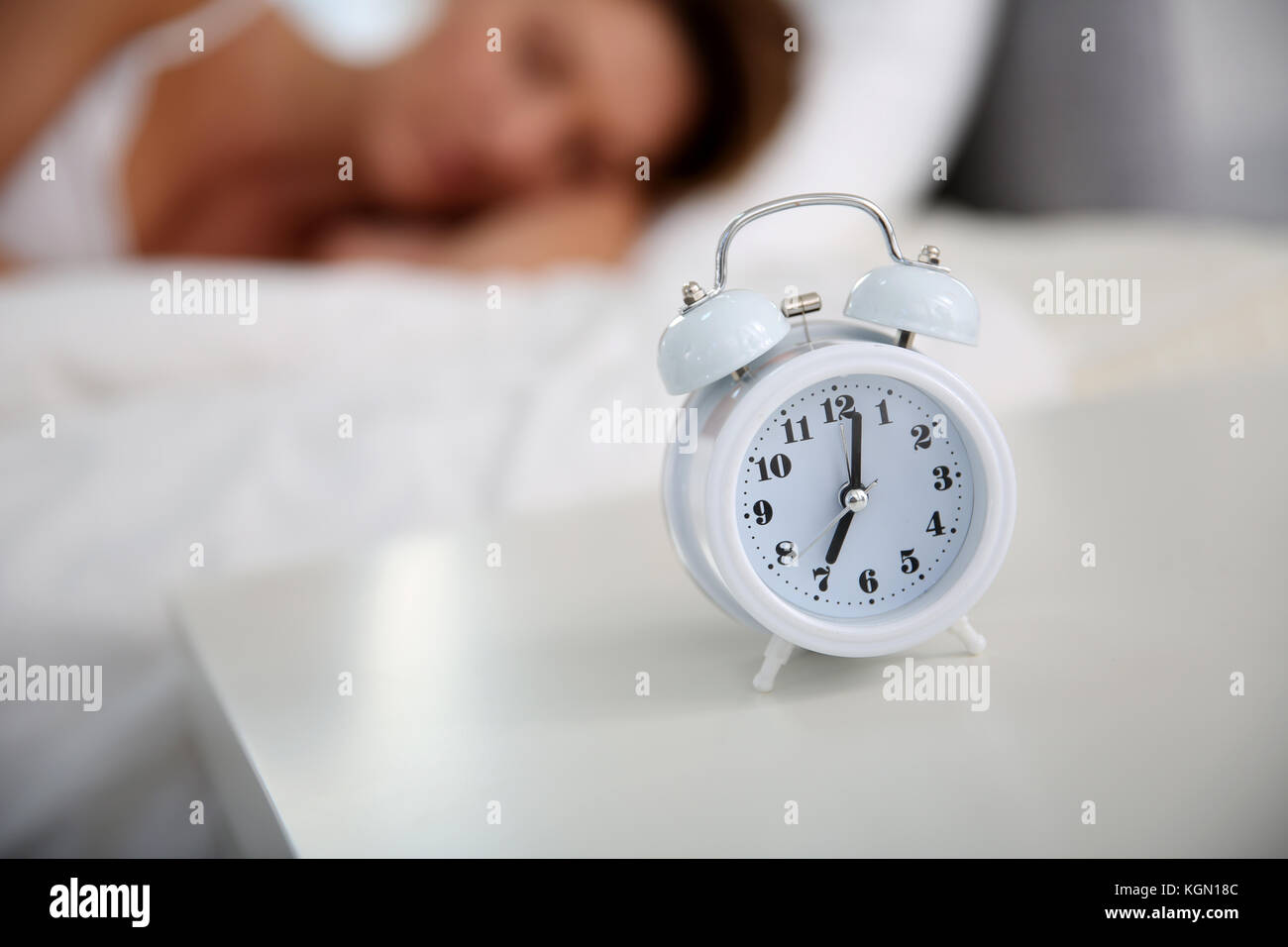 Closeup of alarm clock set on bedroom table Stock Photo - Alamy