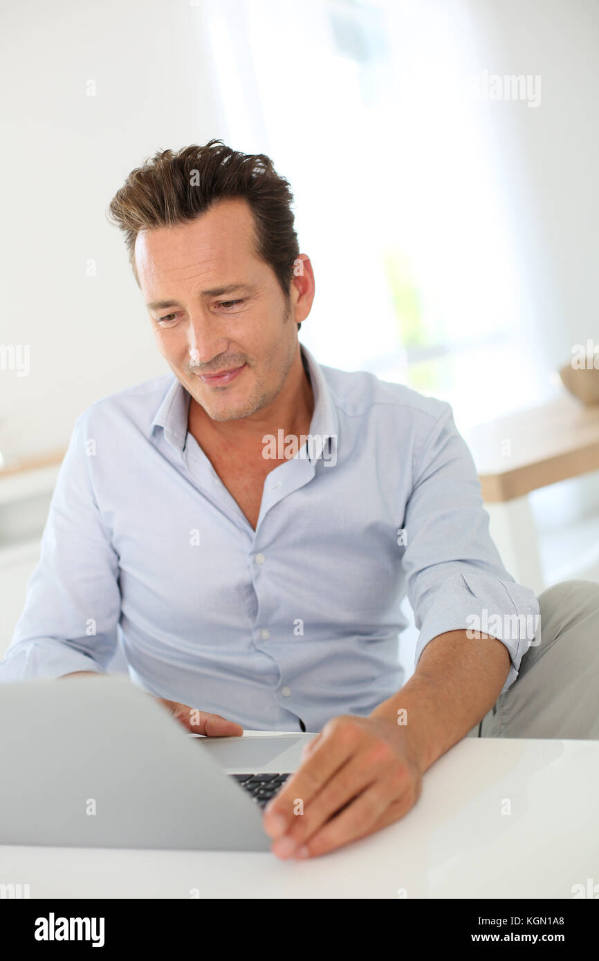 40-year-old man using laptop computer at home Stock Photo - Alamy