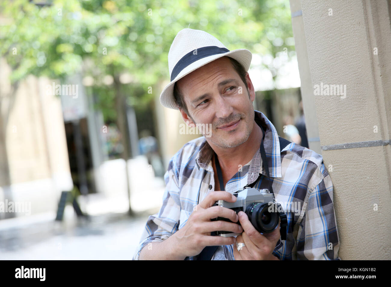 Photographer in town doing a photo reportage Stock Photo - Alamy
