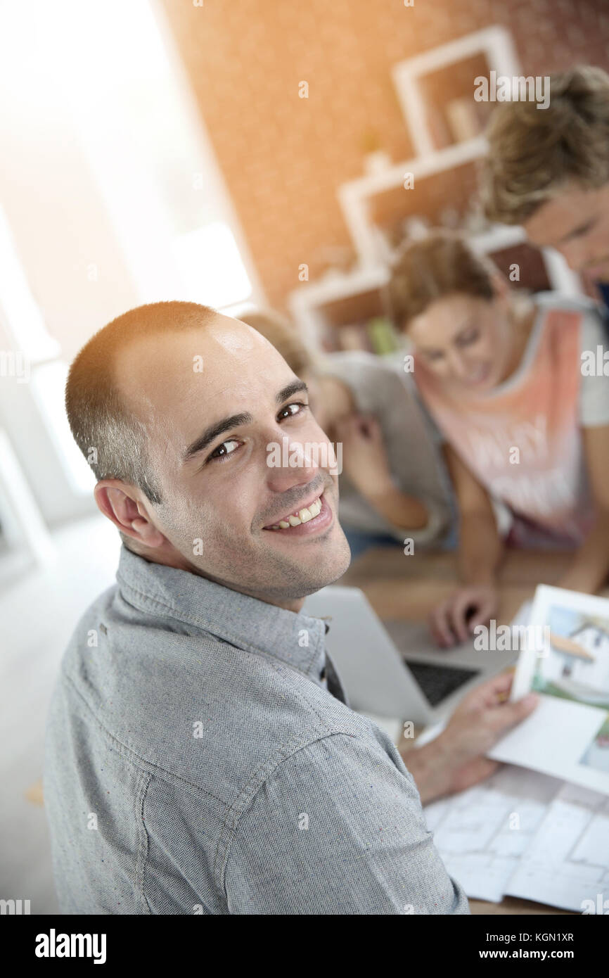 Cheerful guy sitting in front of desktop computer Stock Photo - Alamy