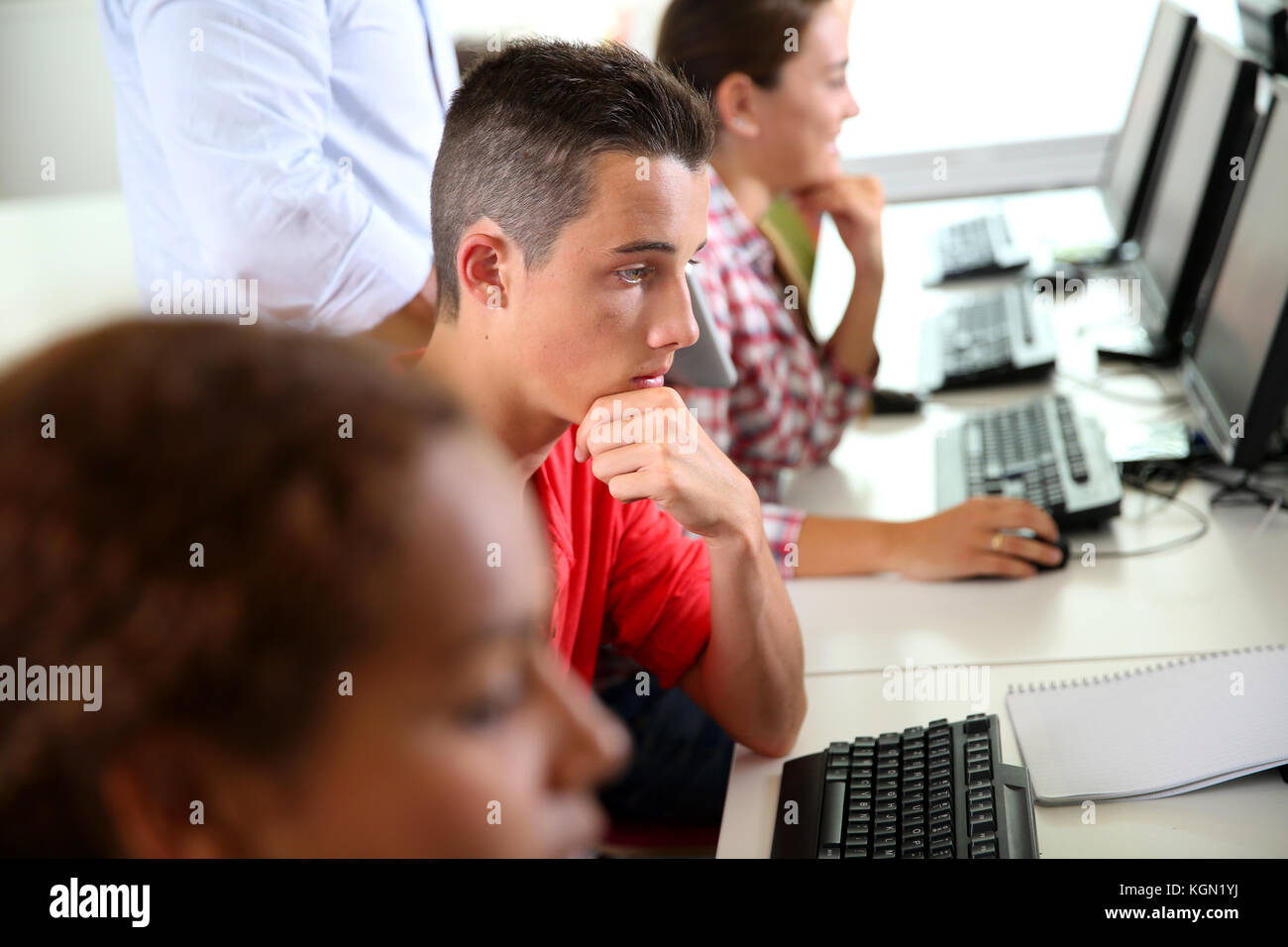 Group of young people in computing class Stock Photo - Alamy