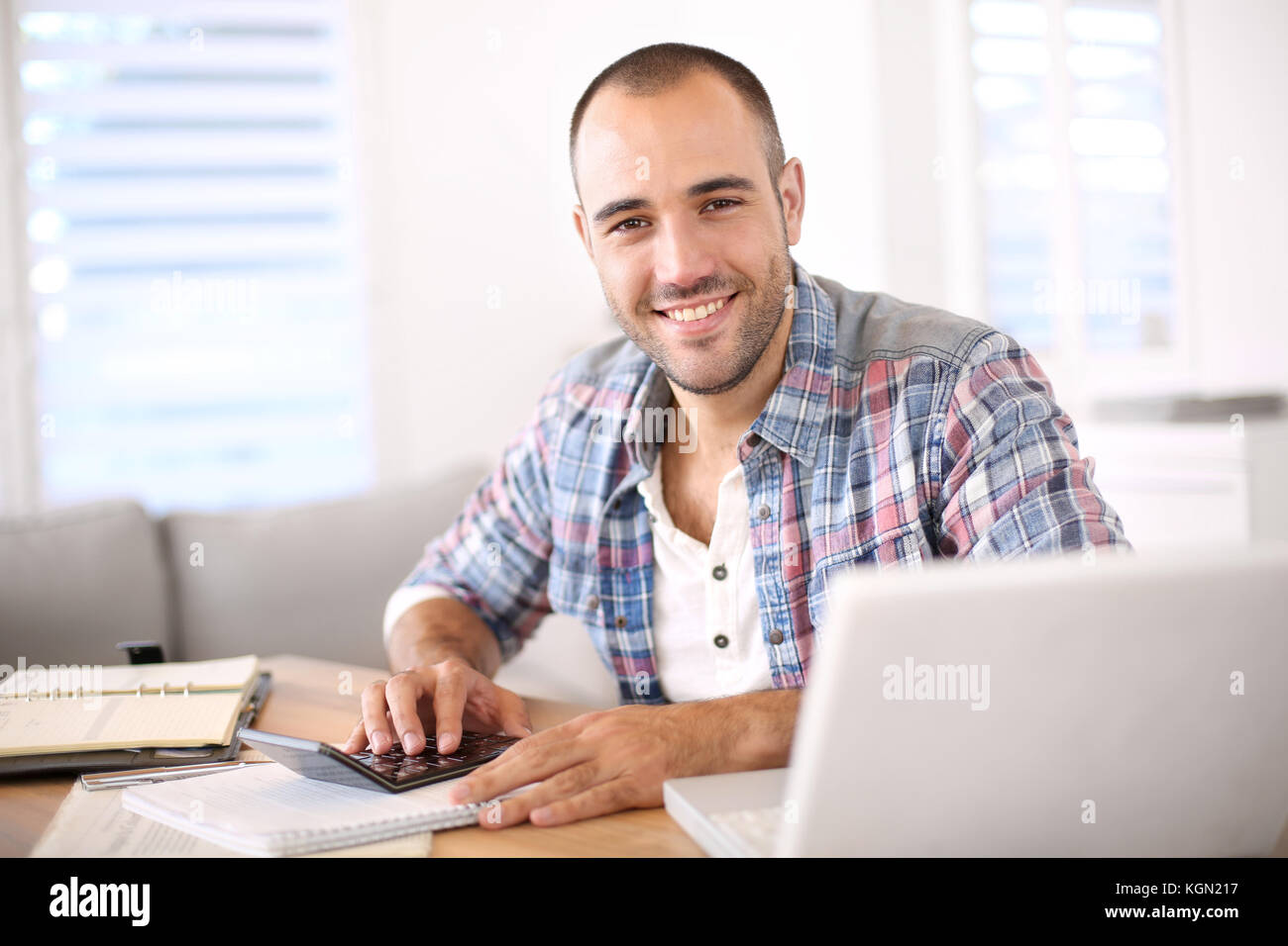Man working on laptop computer from home Stock Photo - Alamy