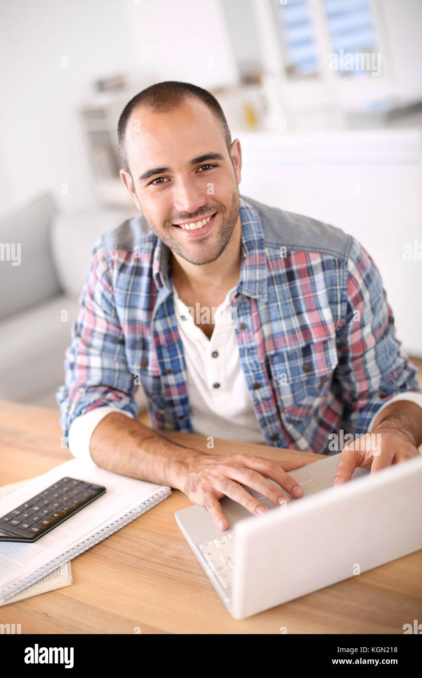 Man working on laptop computer from home Stock Photo - Alamy