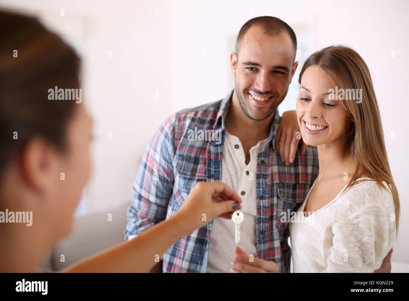 Cheerful couple getting keys of their new home Stock Photo - Alamy