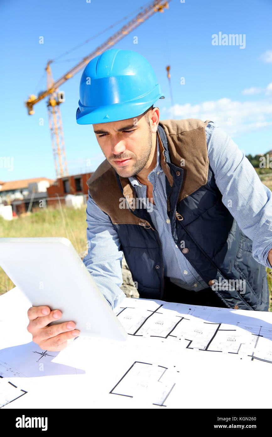 Engineer using tablet by construction site Stock Photo - Alamy