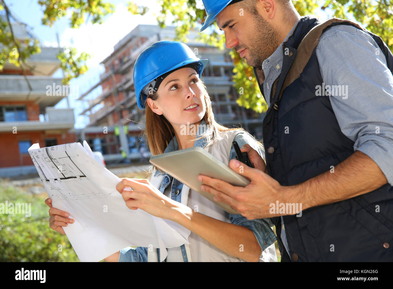 Construction engineers working together on site Stock Photo - Alamy