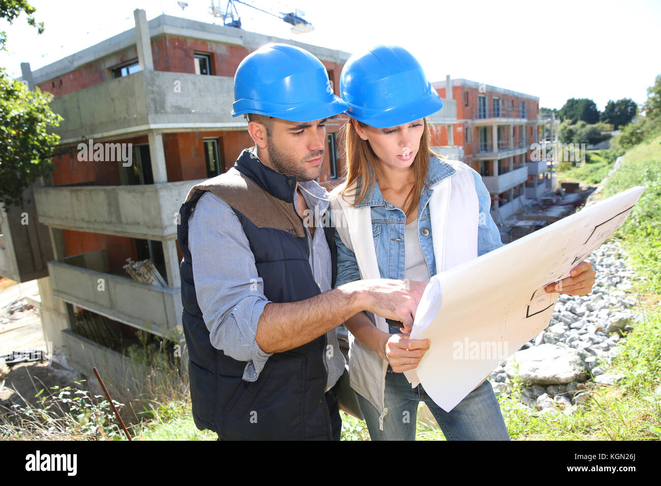 Construction engineers working together on site Stock Photo - Alamy